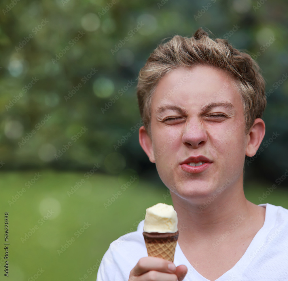Teenage Boy With A Brain Freeze After Eating An Ice Cream Cone Stock