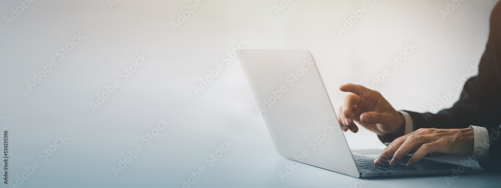 Person typing on laptop keyboard and pointing at screen, businessman ...