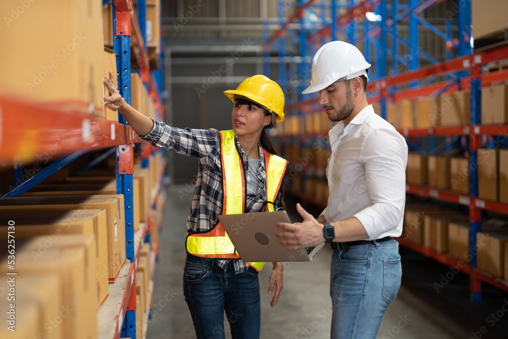 Supervisor and manager smiling happy holding laptop computer on hand ...