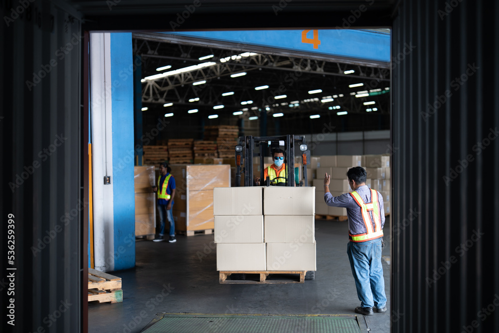 Warehouse worker open doors steel 40 feet container and ask forklift ...