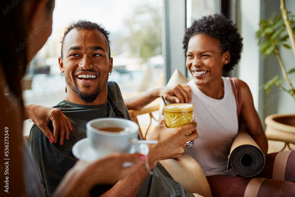 Laughing friends sitting together in a cafe after the gym Stock Photo ...