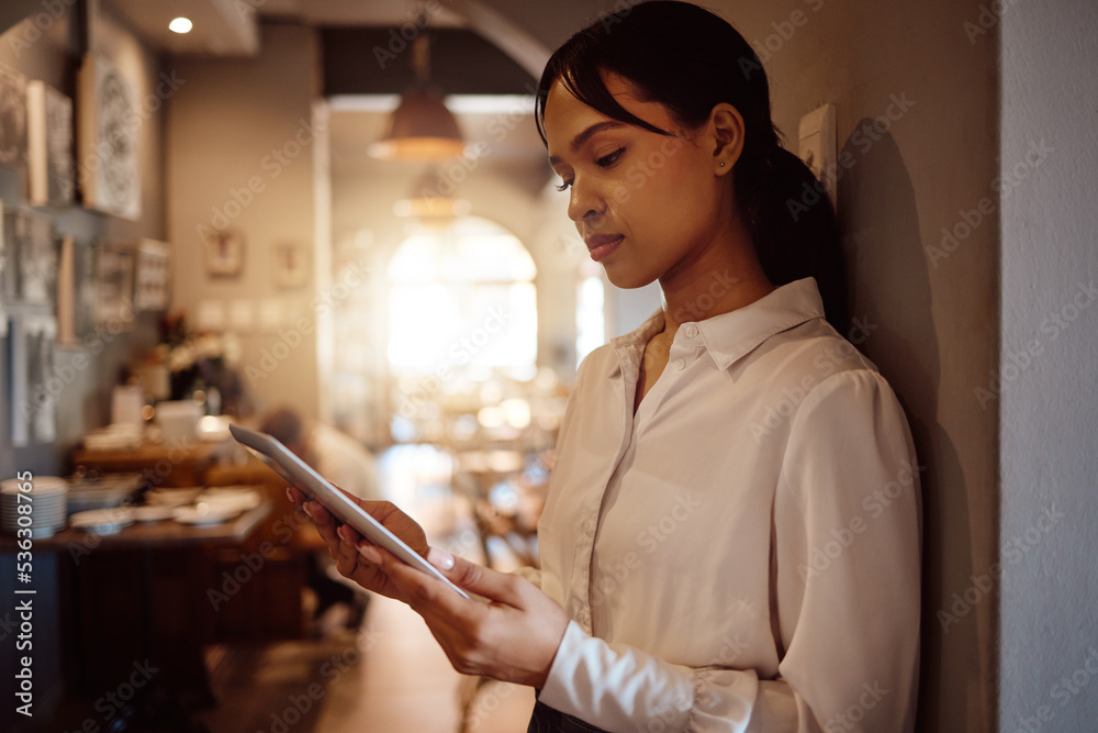 Small business cafe, tablet planning and restaurant manager check ...