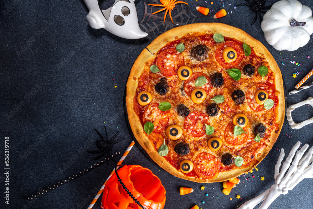 Halloween creative food. funny monster pizza decorated with creepy eyes ...