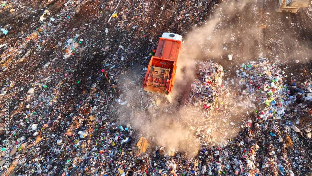 Garbage truck unloads rubbish. Landfill with solid household waste ...