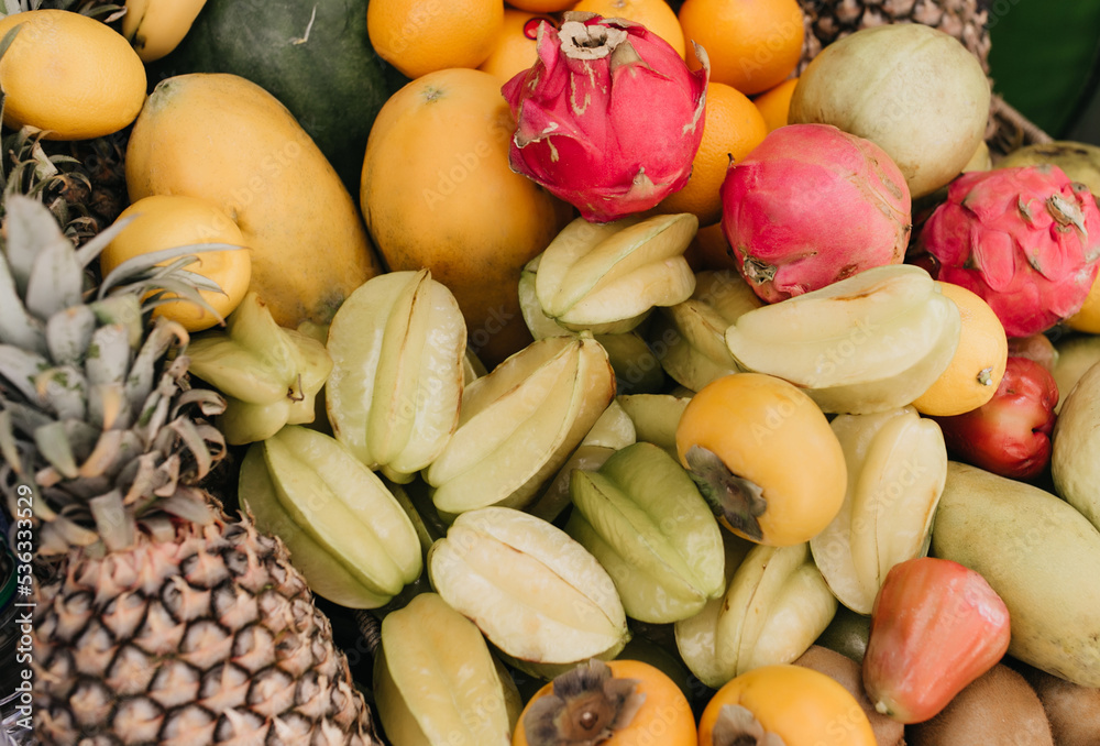 Picture of exotic fruits. Overhead photo of pineapple, carambola and ...