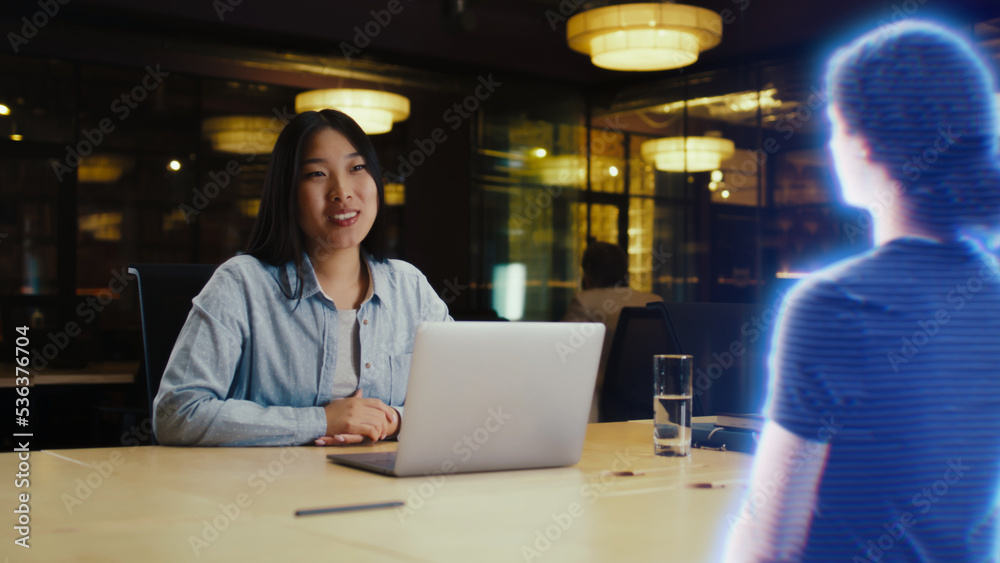 Young asian woman receives a call via an abstract futuristic screen ...