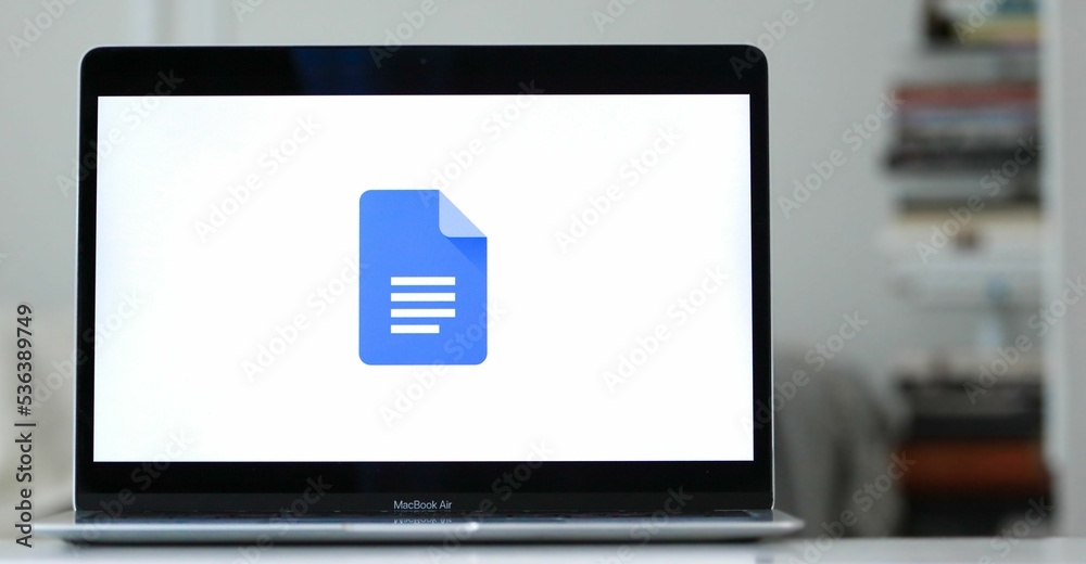 Logo design of google docs on a laptop screen in blurred background ...
