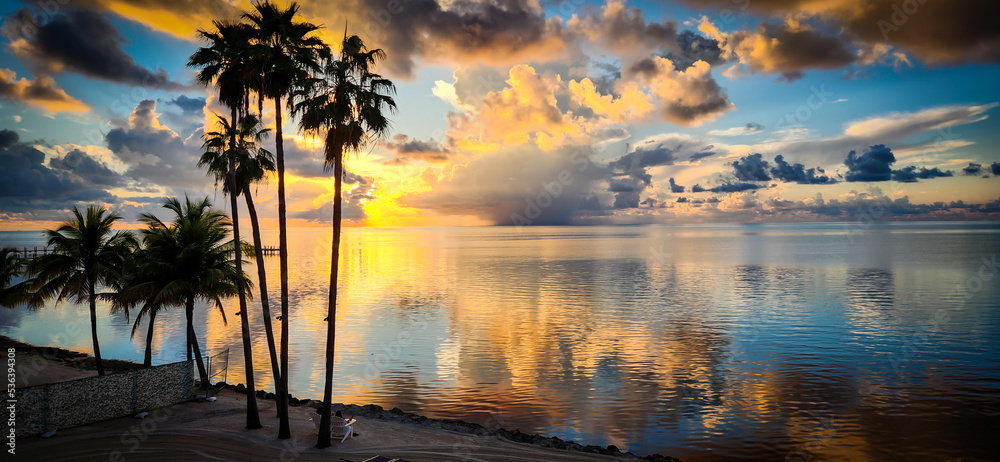 Vibrant morning sunrise over glassy water in the Florida Keys Orange ...