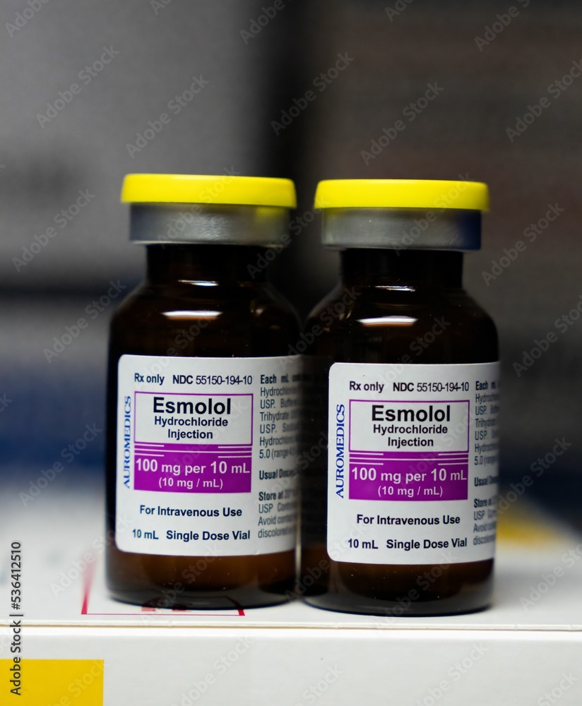 Vertical view of two bottles of Esmolol 100mg placed over the box Stock ...