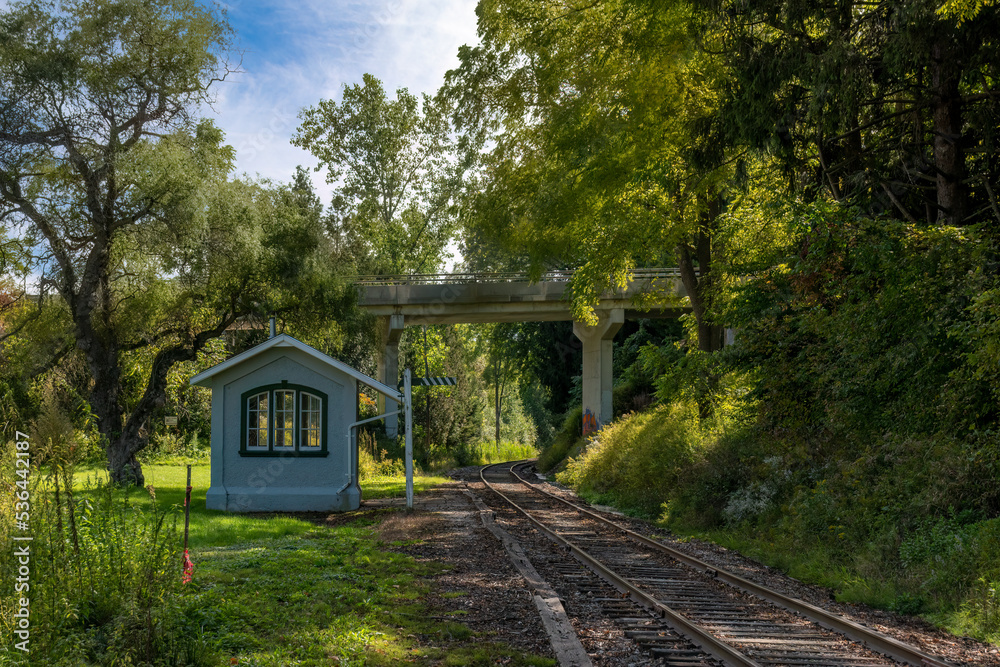 A small building, not much larger than an outhouse, stands beside a ...