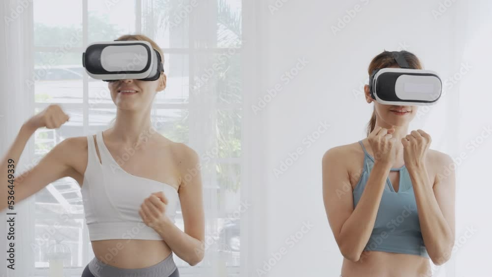Two young caucasian woman wearing vr headset while workout and exercise ...