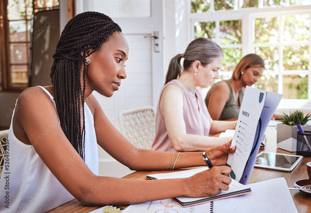 Black woman with business documents, writing at desk and women working ...