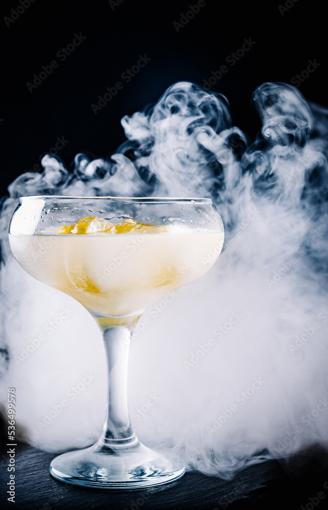 Alcohol gin cocktail in the glass with smoke on dark background. Stock ...