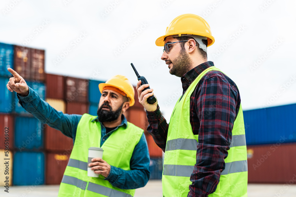 Industrial engineers working in logistic terminal of container cargo ...