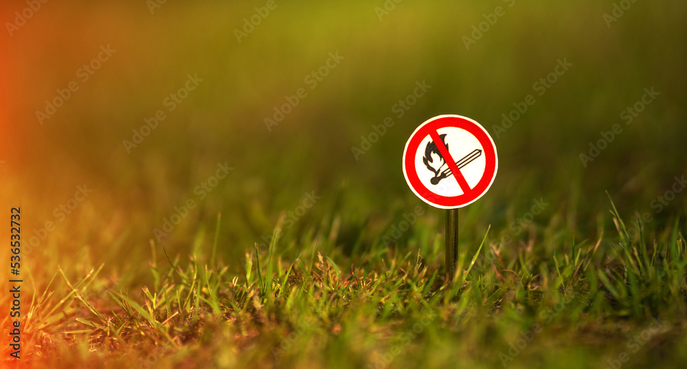 Round crossed-out sign with a match. It is forbidden to make a fire ...