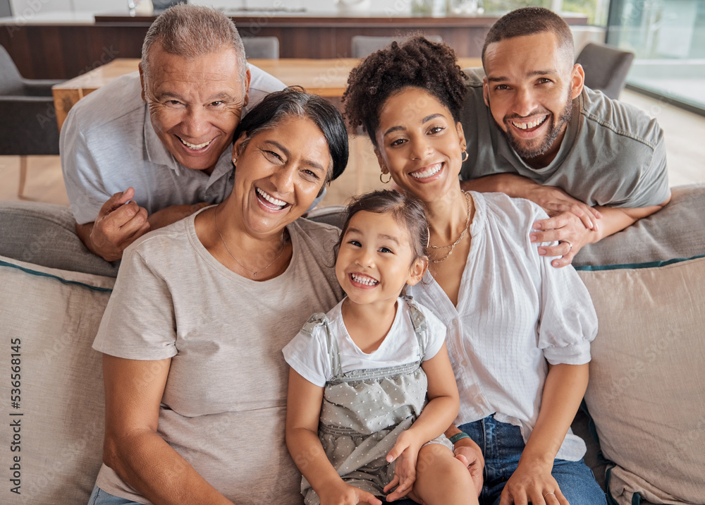 Happy family of couple, grandparents and child on sofa in living room ...