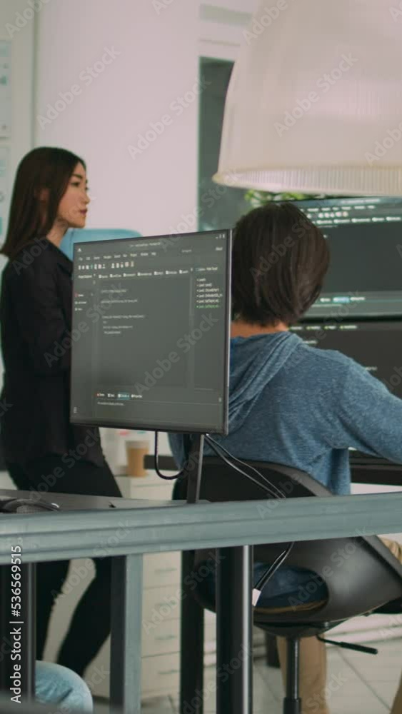 Vertical video: Diverse artificial intelligence programers typing system code and programming ...
