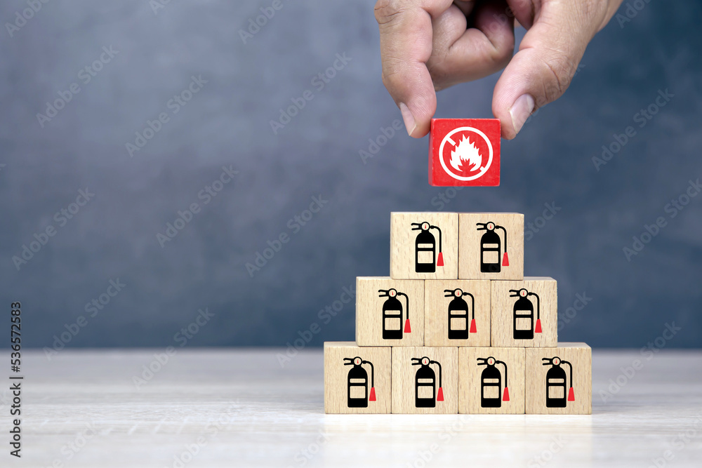 Hand choose cube wooden block stack with fire prevent icon with fire ...