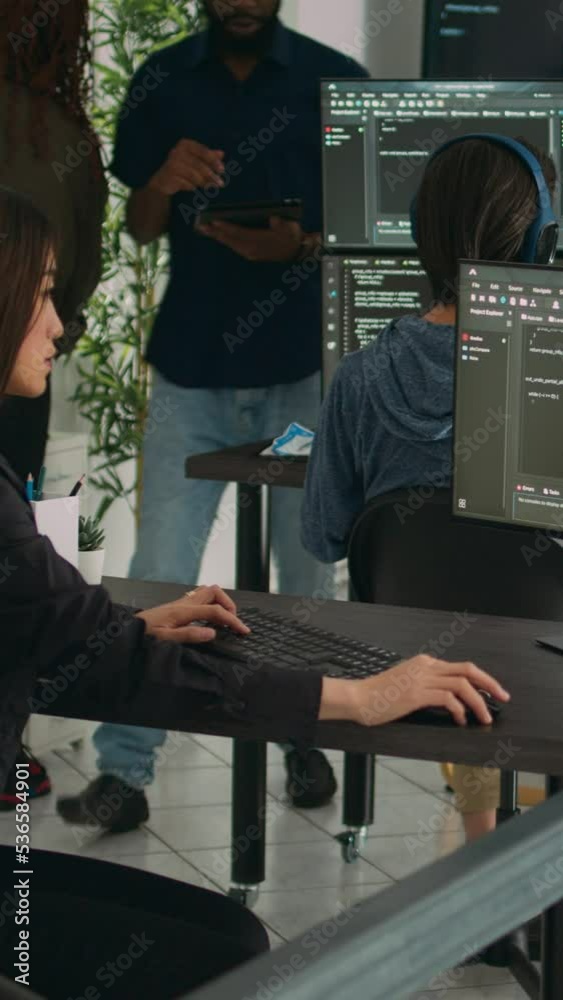 Vertical video: Woman programer typing source code on computer keyboard ... Vertical video: Woman programer typing source code on computer keyboard ...