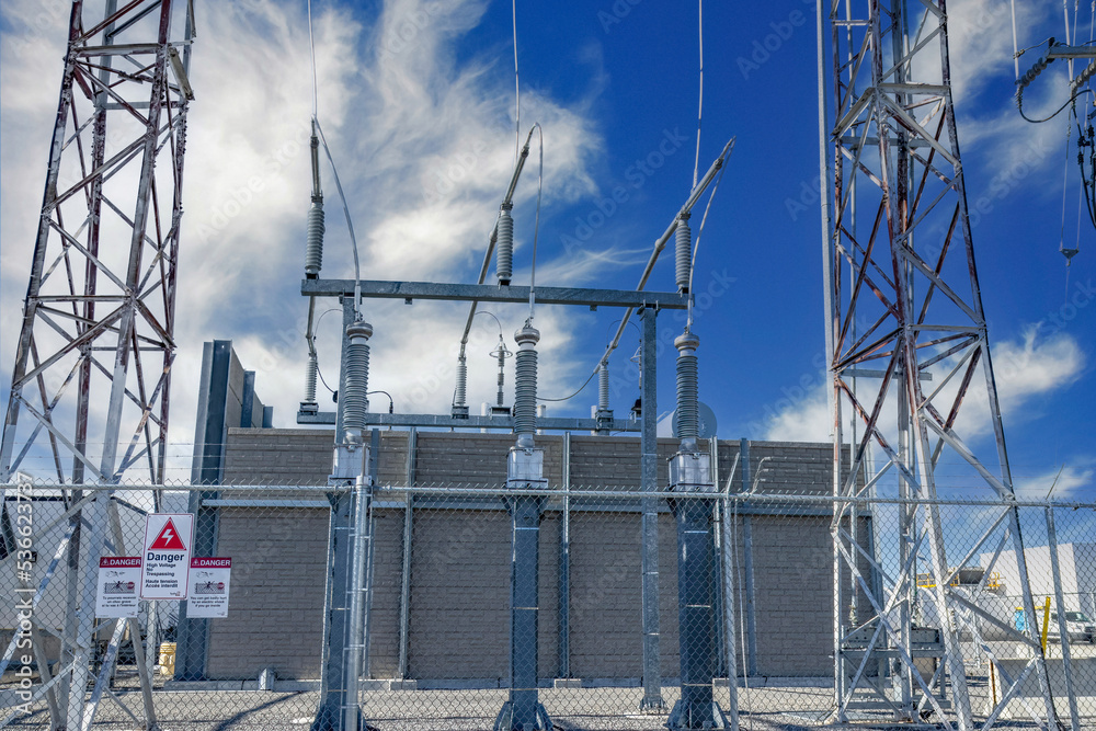 Power transformer substation in daytime, metal towers, supports ...