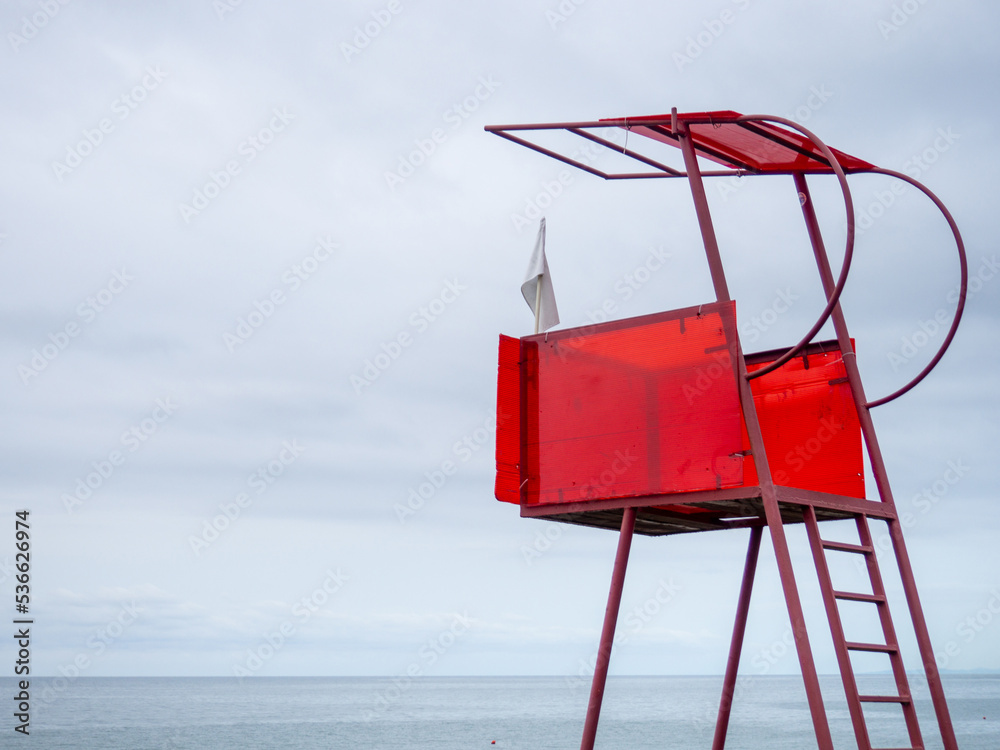 observation tower on the beach with a white flag. Rescue tower ...