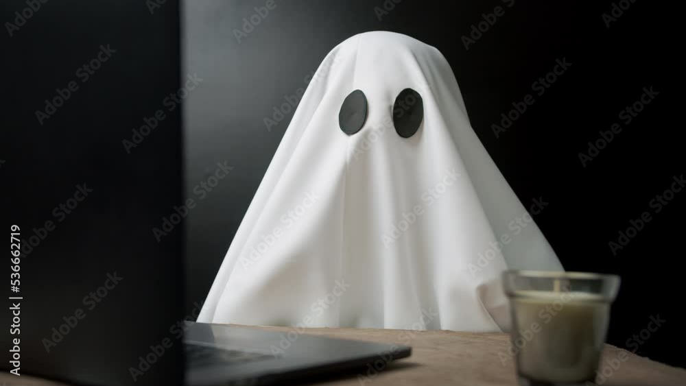 Ghost writing an article on laptop. Person working or studying in ...