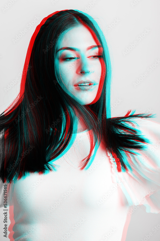 Beautiful woman with long dark hair studio portrait in RGB color split ...