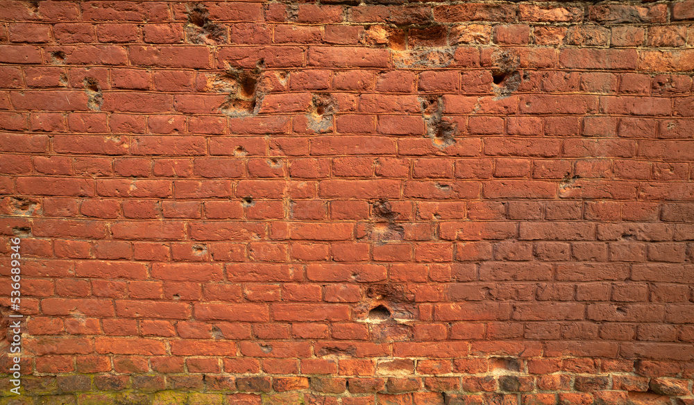 Shell marks on the red brick wall. The consequences of splinters ...