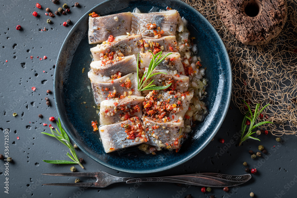 Sour and spicy marinated fish with onion and dry tomatoes. Stock Photo ...