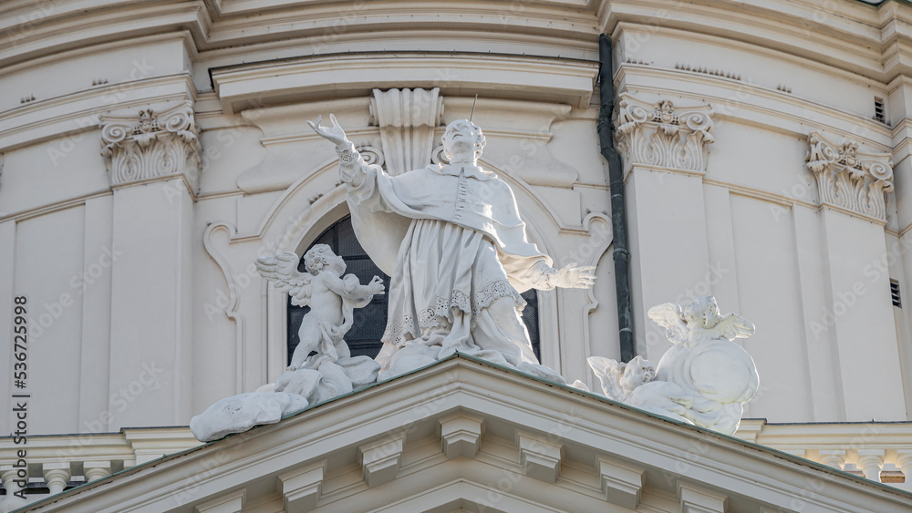 Front view of Saint Karl Cathedral main gate sculptures with a praying ...