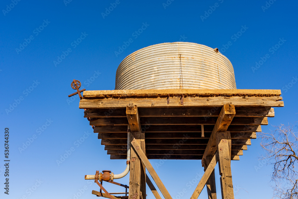 Looking up underneath a high tank stand with a rusting water tank on ...