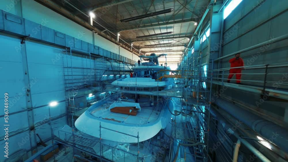Luxury yacht construction under hangar in a shipyard. 4K. 1 Stock Video ...