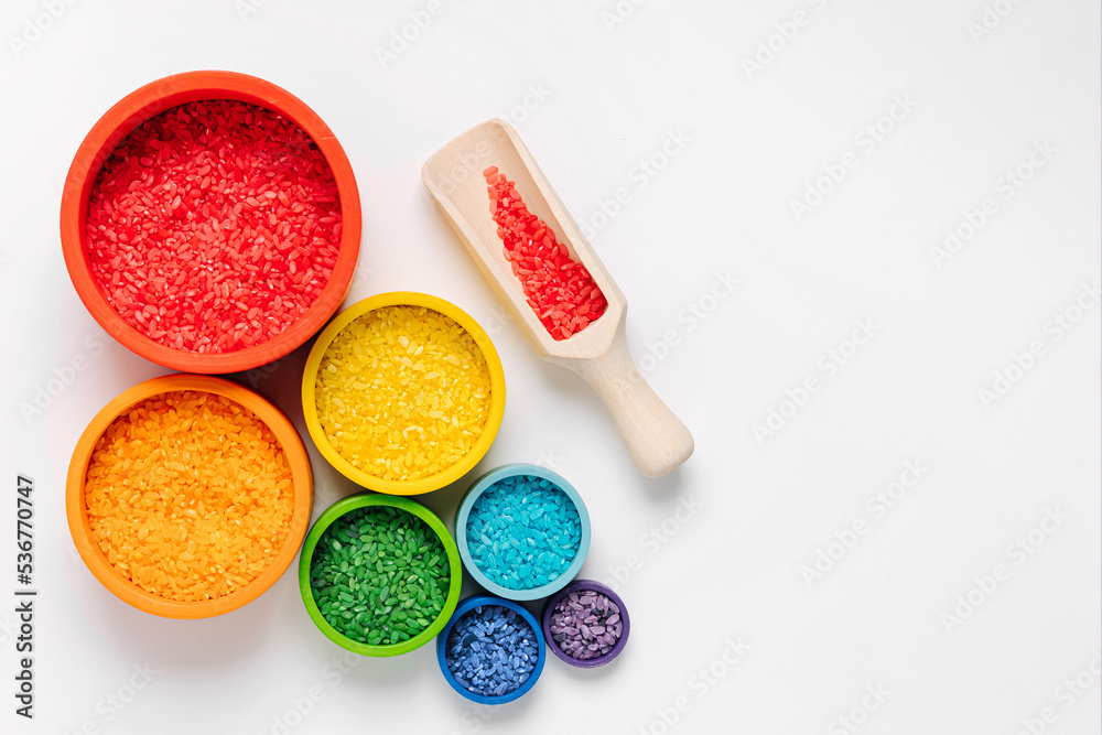 Bowls in rainbow colors with colored rice and scoops. Sensory bin ...