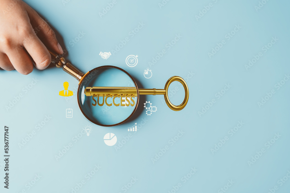 Business Success key to target. Hand holding Magnifier glass focus to ...
