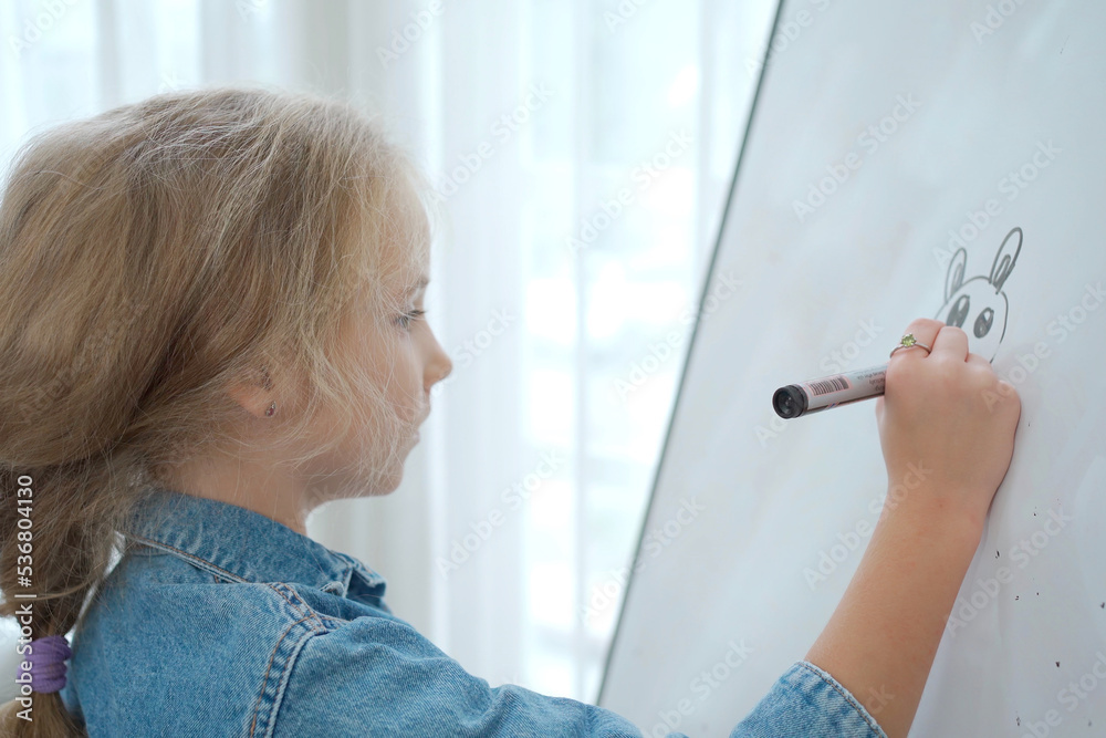 Lovely little cute girl enjoy drawing a picture and painting on a ...