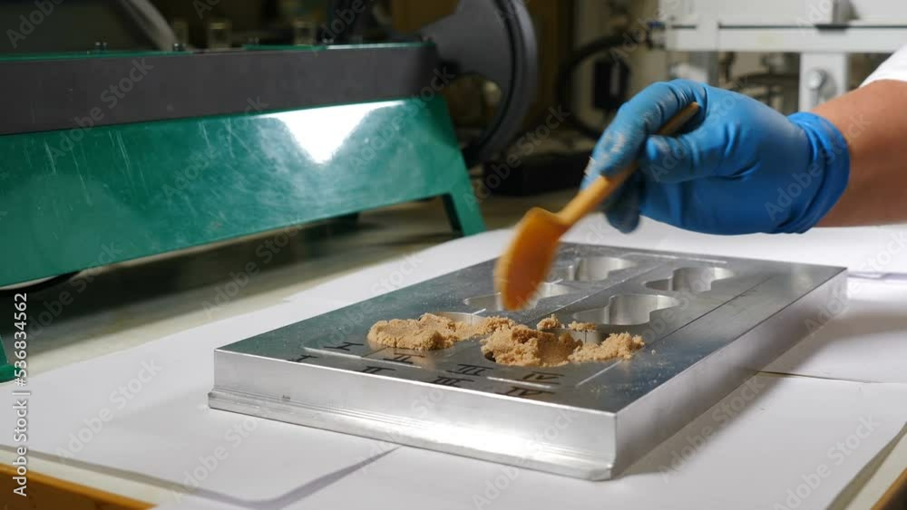 Preparing sand form for tensile test in laboratory of chemical factory ...