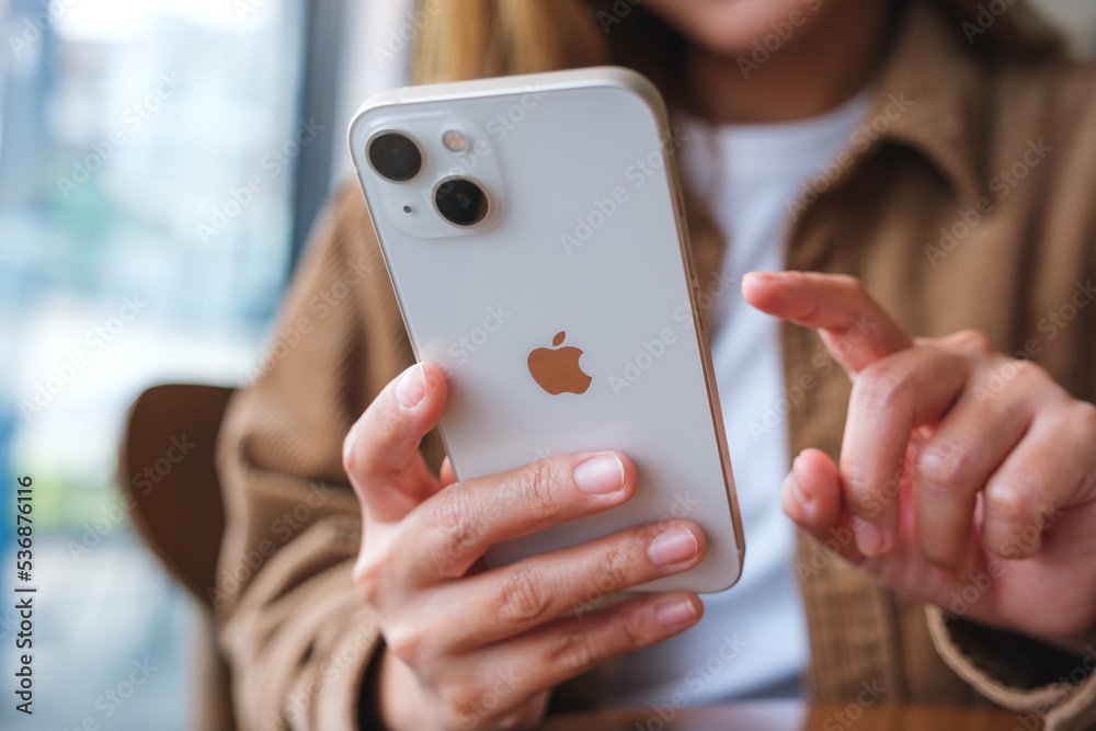 Oct 6th 2022 : A woman holding and touching on Iphone 13 smart phone ...