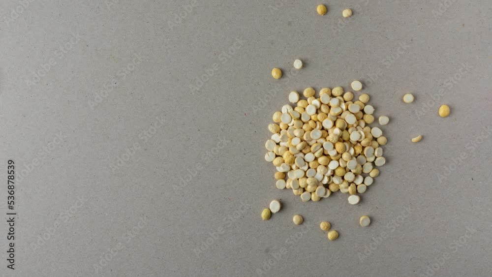 falling stop motion of roasted or fried bengal gram on a gray textured ...