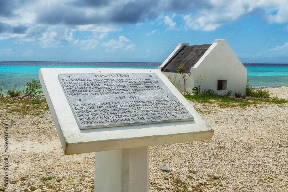 A sign located at the historic slave huts on the island tells the ...