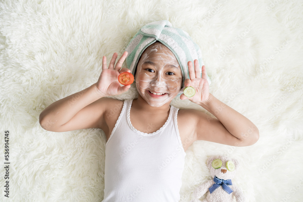 Top view Asian happy child little girl wear a turbine and apply cream ...