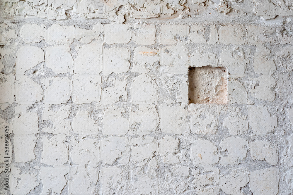 Texture old wall with ceramic tiles fall off the wall and hole. On the ...