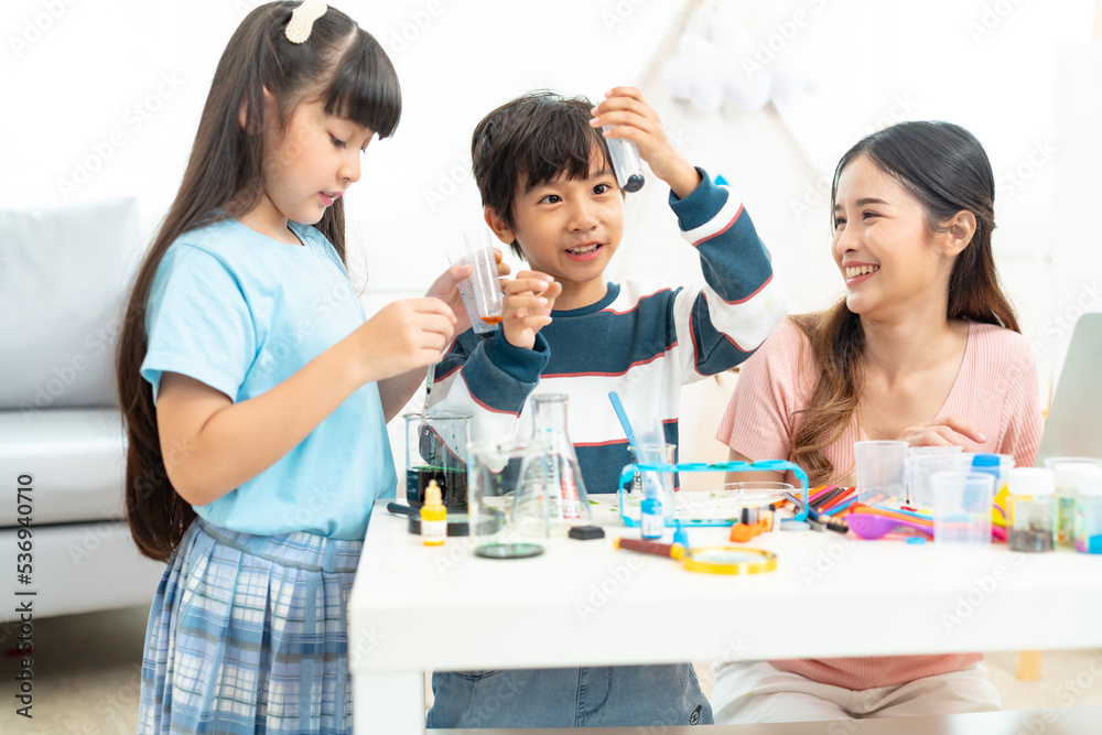Kid playing a microscope for scientific experiments at home.Young ...