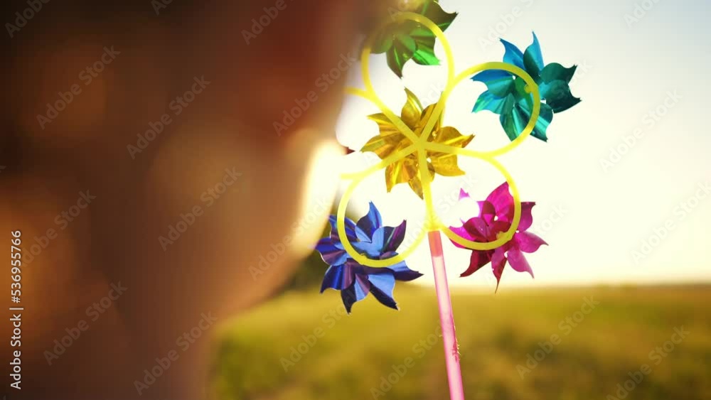 baby pinwheel. little girl silhouette plays with windmill a toy wind in ...