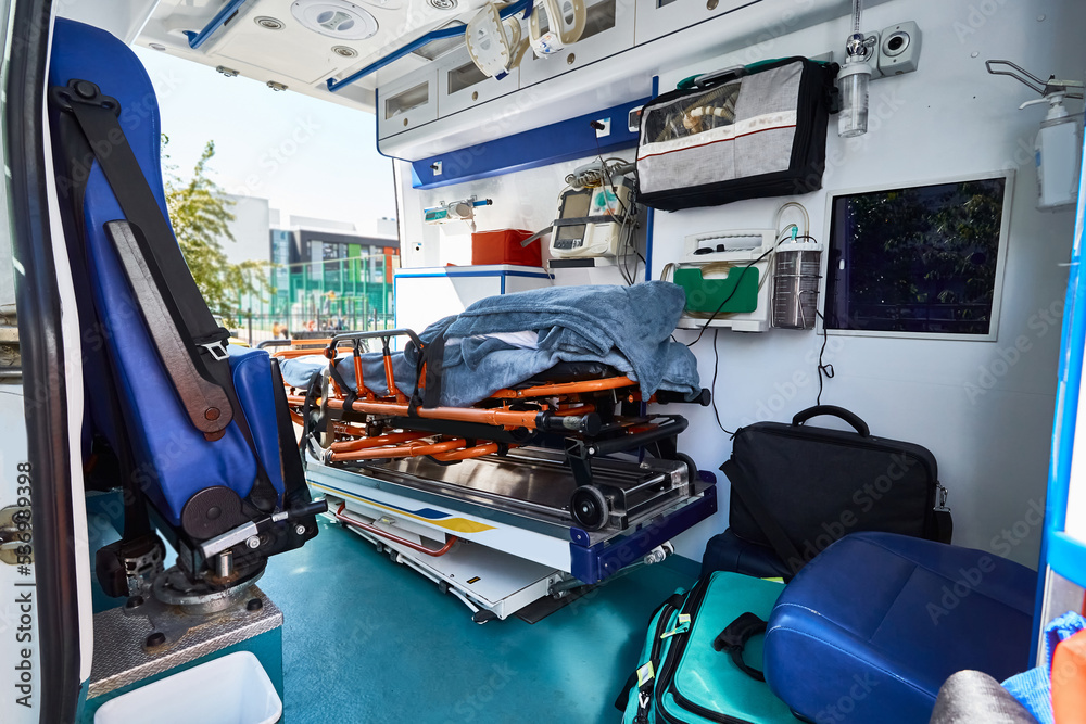 Ambulance interior with gurney defibrillator and other medical equipment and supplies carried onboard. EMS Photos Adobe Stock