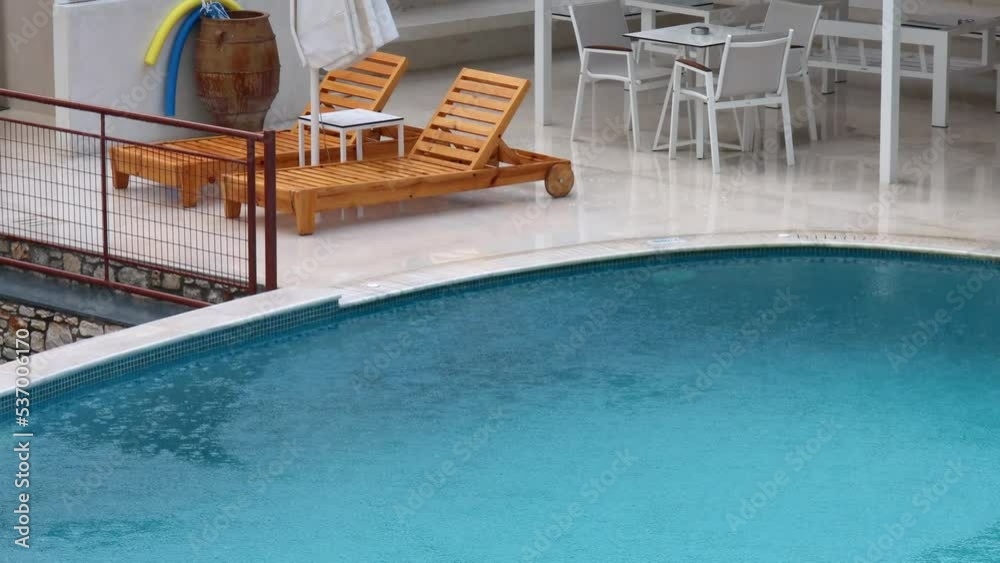 Rain Drops Falling Onto Water In Swimming Pool On Rainy Holiday In ...