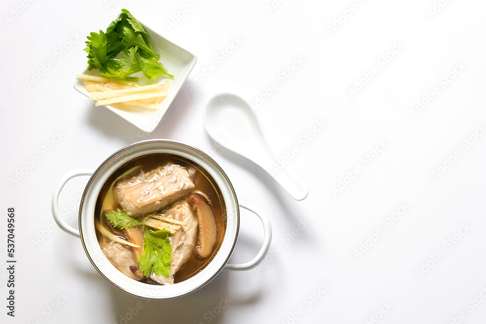 Pot of soup with sea bass fish and herb, healthy meal. Overview shot ...