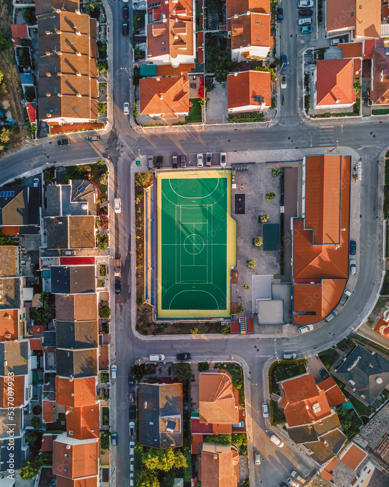 Aerial view of a football field in a residential district in Arrentela ...