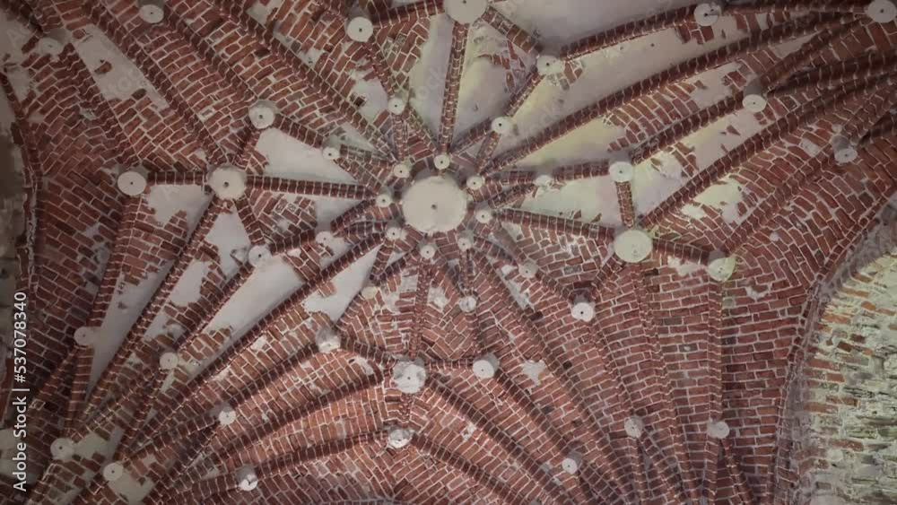 empty old vaulted ceiling made of dark bricks. Historic castle with red ...