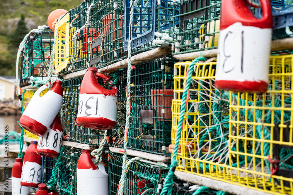 Lobster traps and crab traps with buoys stacked on a dock ready of ...