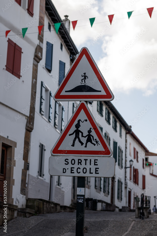 French customized traffic signs. Translation: "School exit". The sign ...